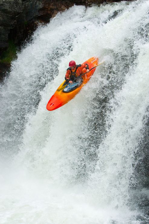 In mid air over a waterfall white water kayaking on the Sarapiqui River ...